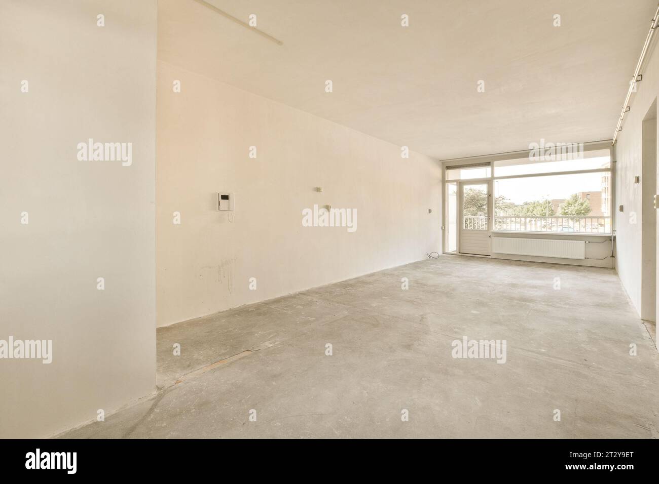 an empty room with white walls and no one person standing in the corner ...