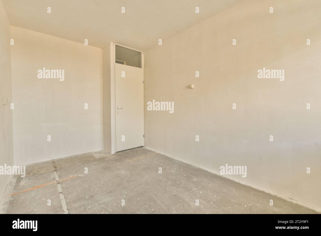 an empty room with white walls and no one door on the other wall there ...