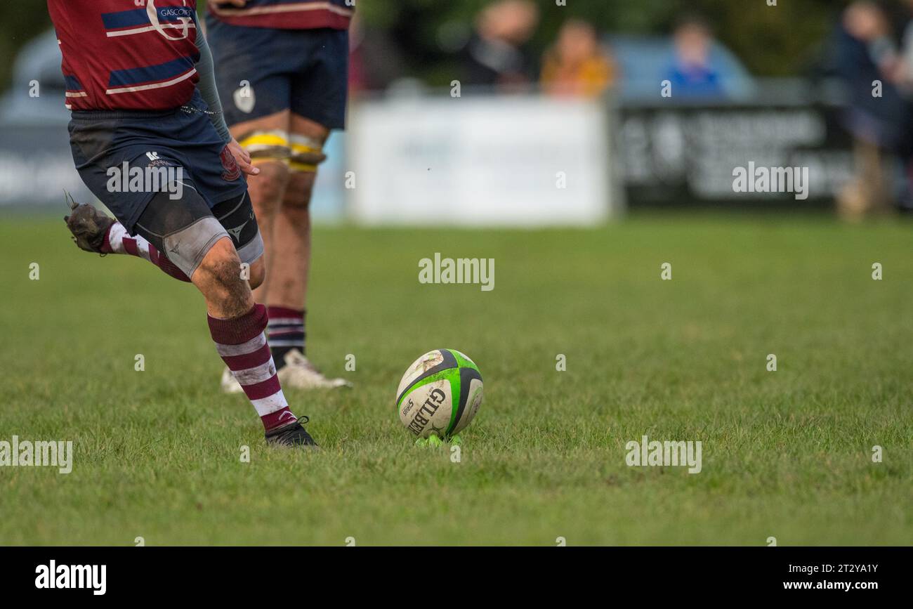 English amateur Rugby Union player running up to kick the rugby ball in ...