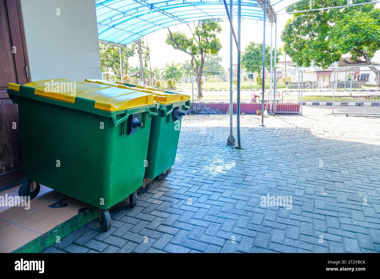 Organized outdoor storage: green plastic waste bins in house yard Stock ...