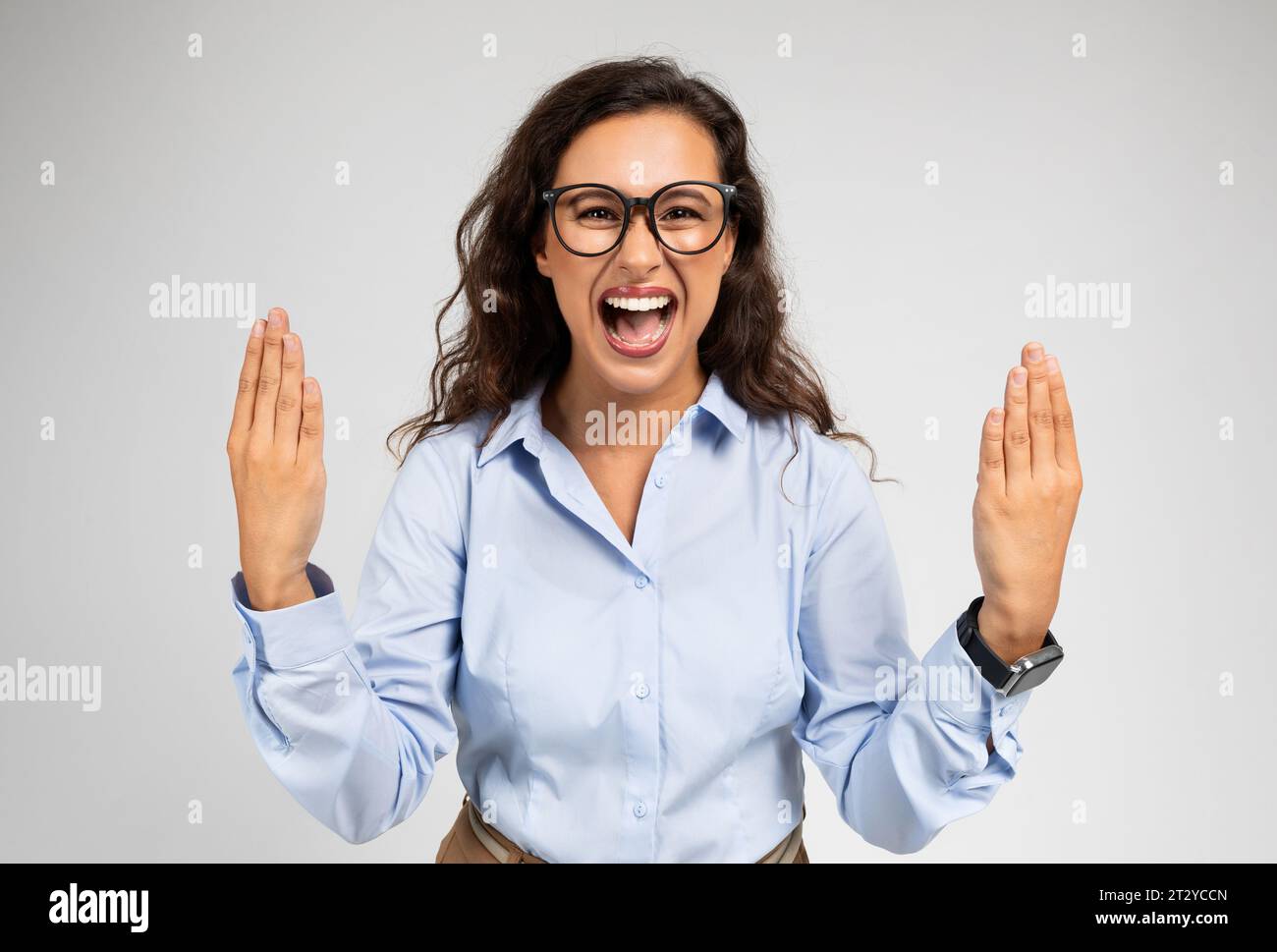 Angry sad adult european woman in formal wear raises hands, screams ...