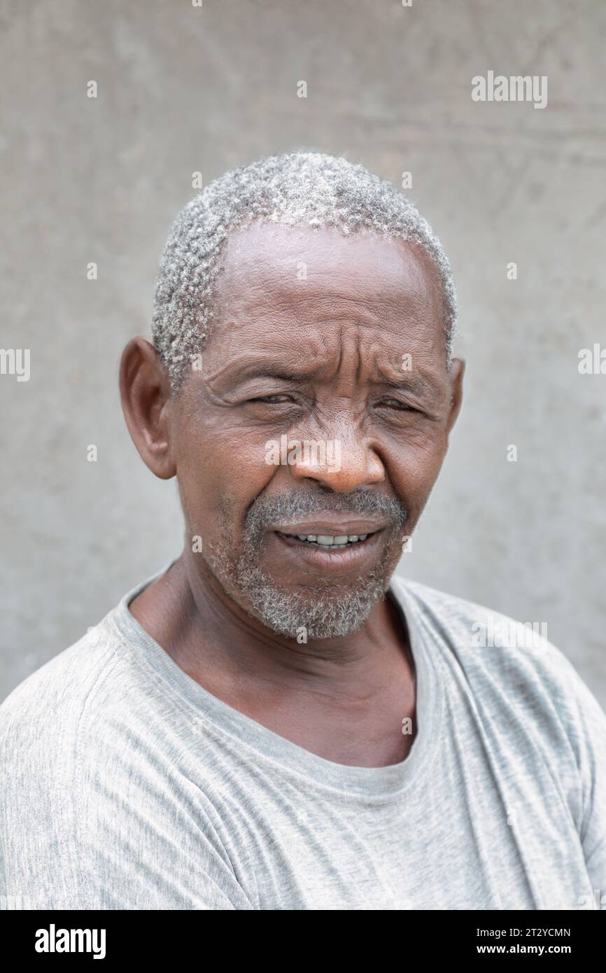 old african man portrait against the wall of his house in the village Stock Photo - Alamy