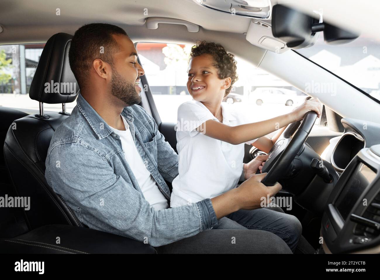 Happy loving black father and son driving car together Stock Photo - Alamy