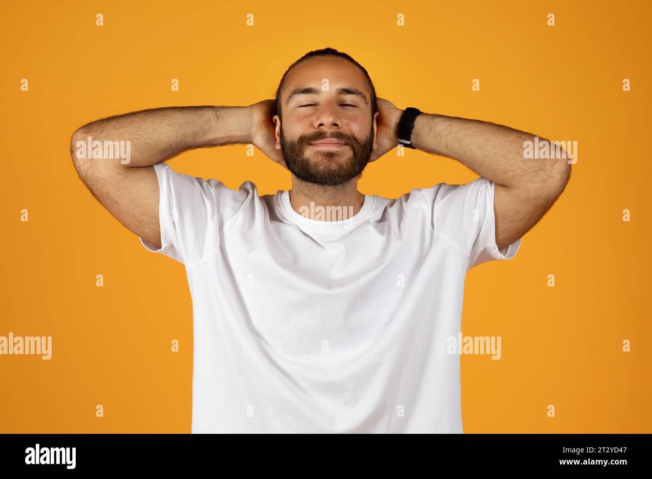 Positive calm young caucasian guy with beard in white t-shirt rest ...