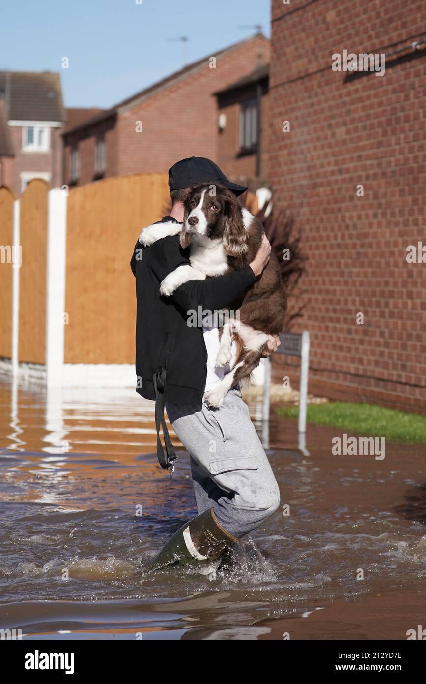 A resident walks through flood water in Retford in Nottinghamshire ...