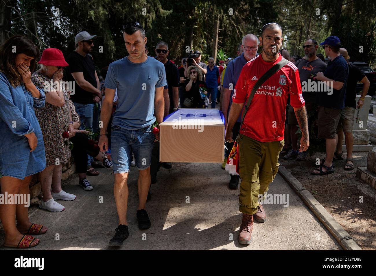 Mourners carry the coffin of Roee Munder during his funeral in Kibbutz ...