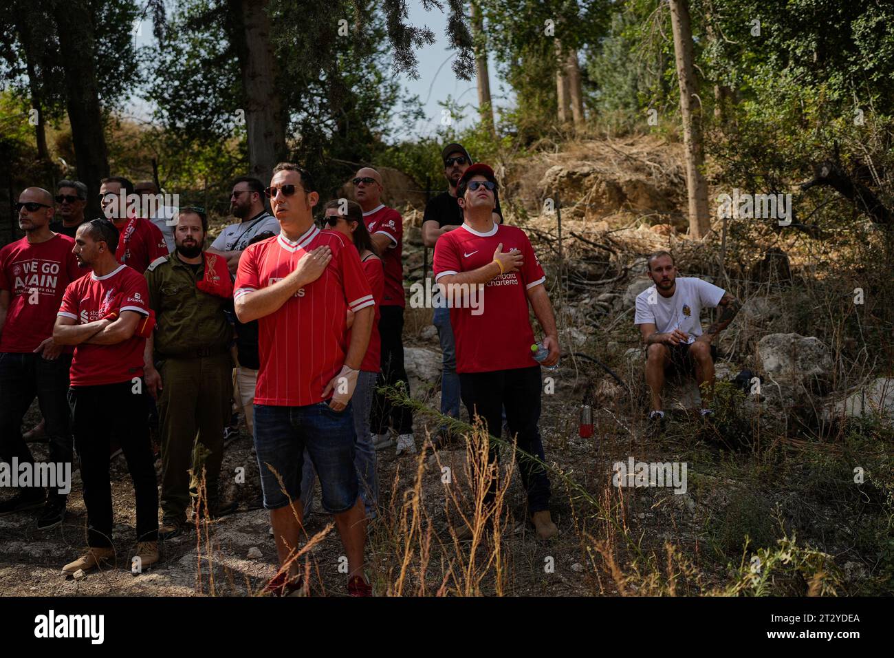 Mourners wearing Liverpool FC shirts attend the funeral of their friend ...