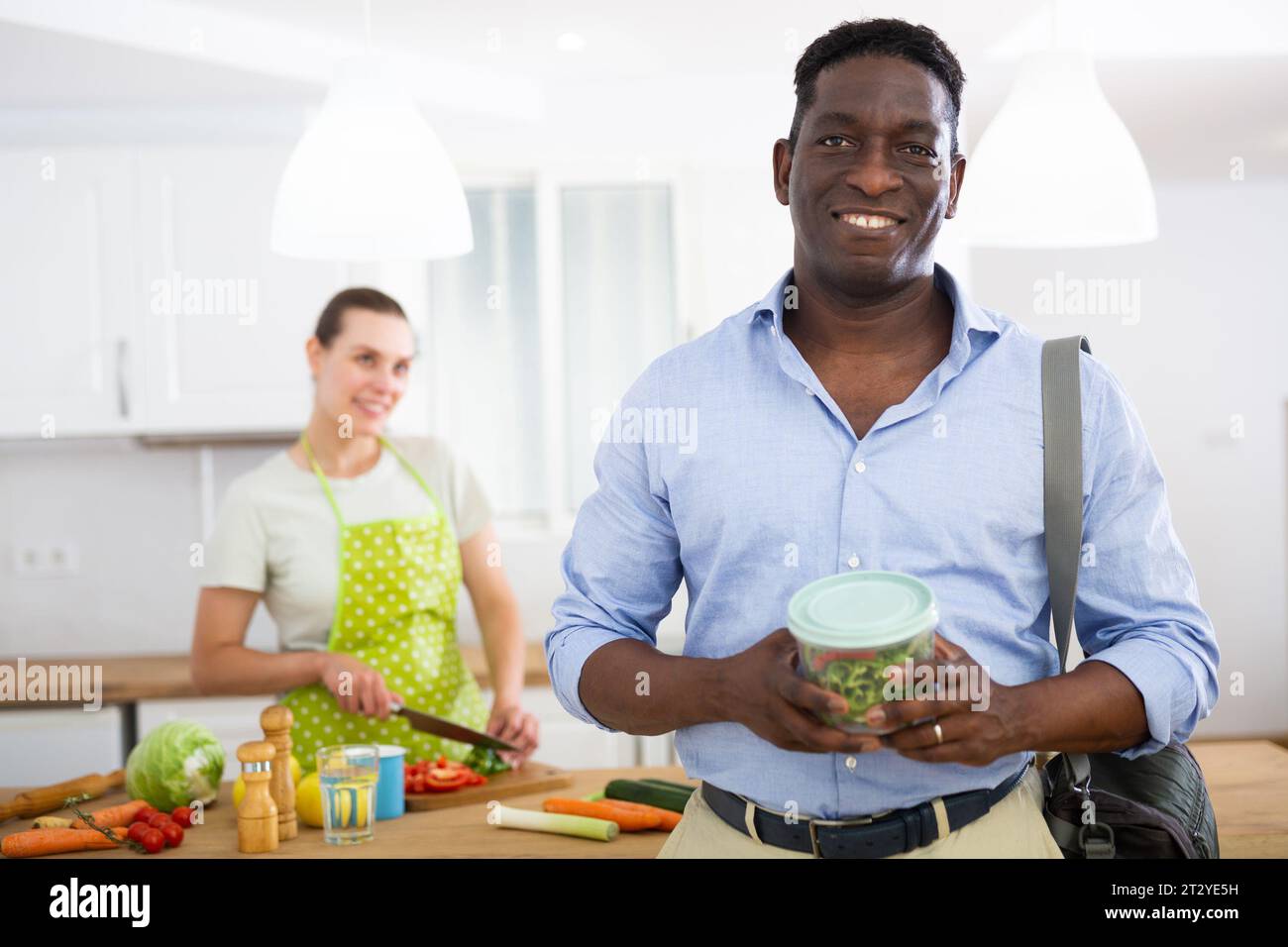 Portrait of positive man with lunch box Stock Photo - Alamy