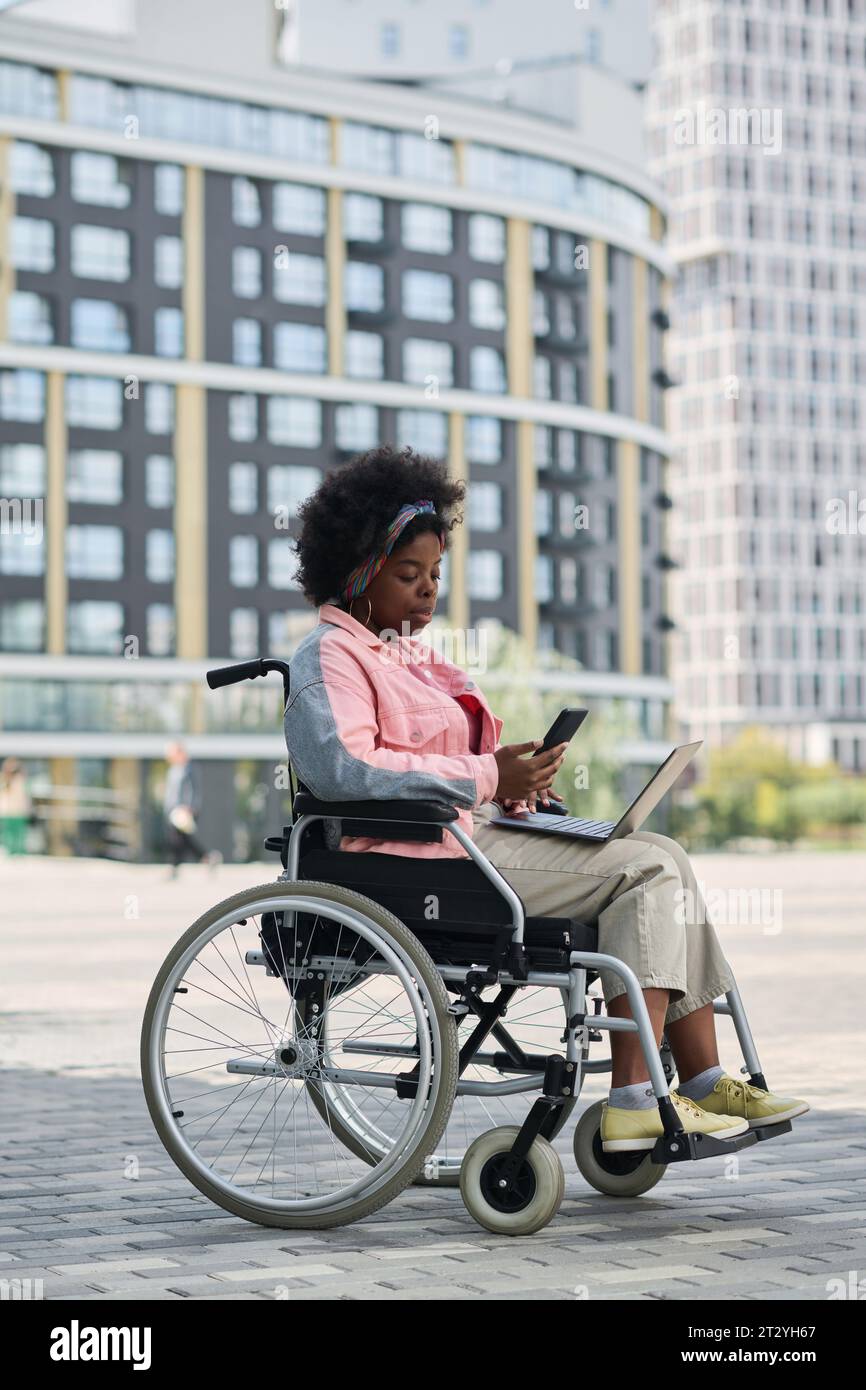 Vertical image of African American woman with disability connecting ...