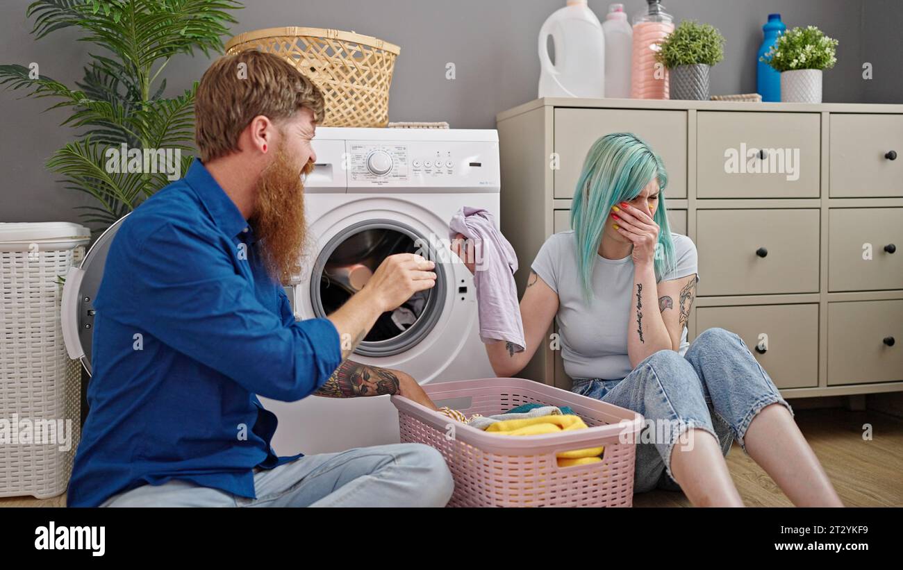 Man and woman couple washing dirty clothes at laundry room Stock Photo ...