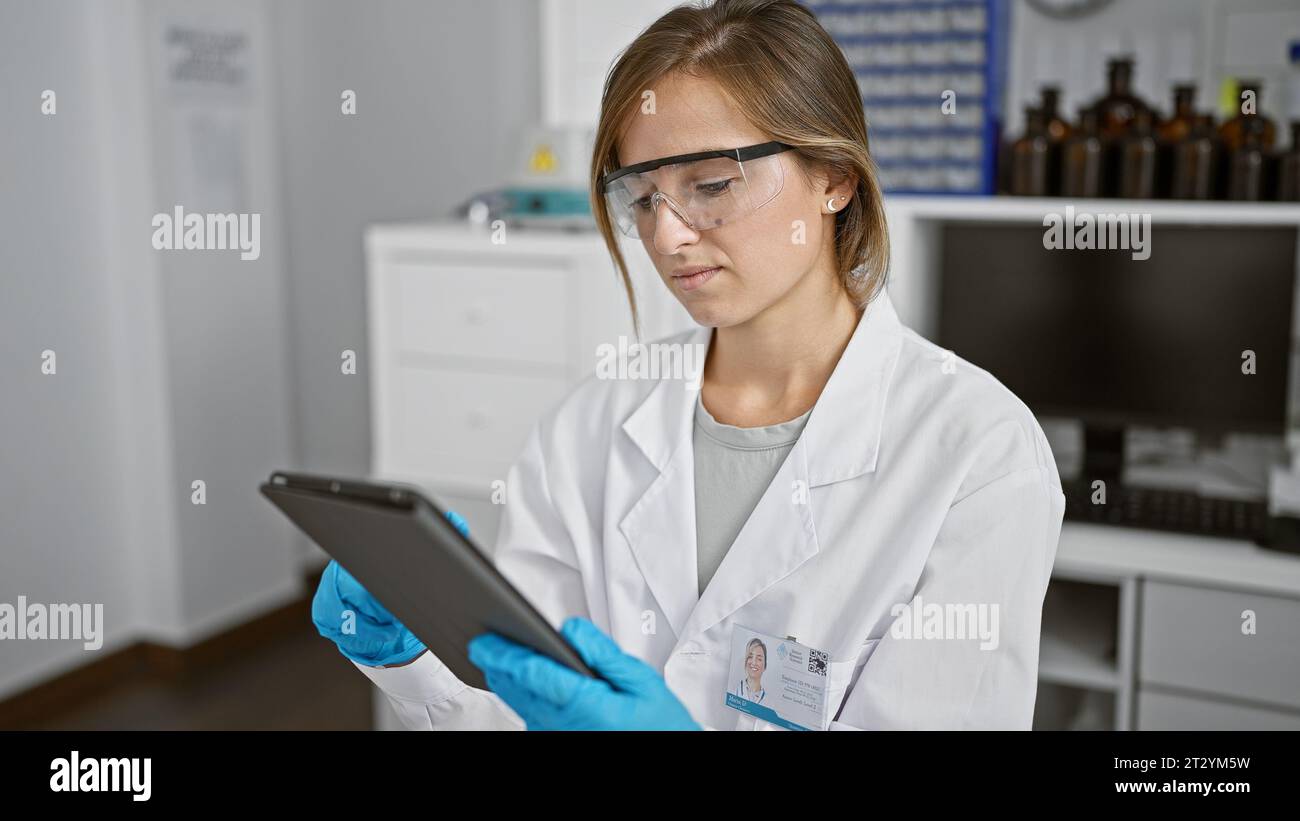 Intrigued young blonde scientist, engrossed in medical analysis, shows ...
