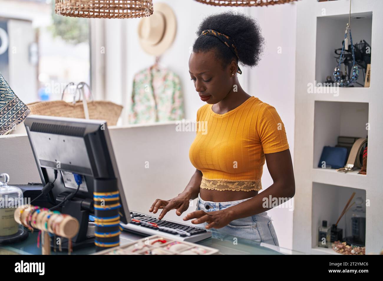 African american woman shop assistant using computer working at ...