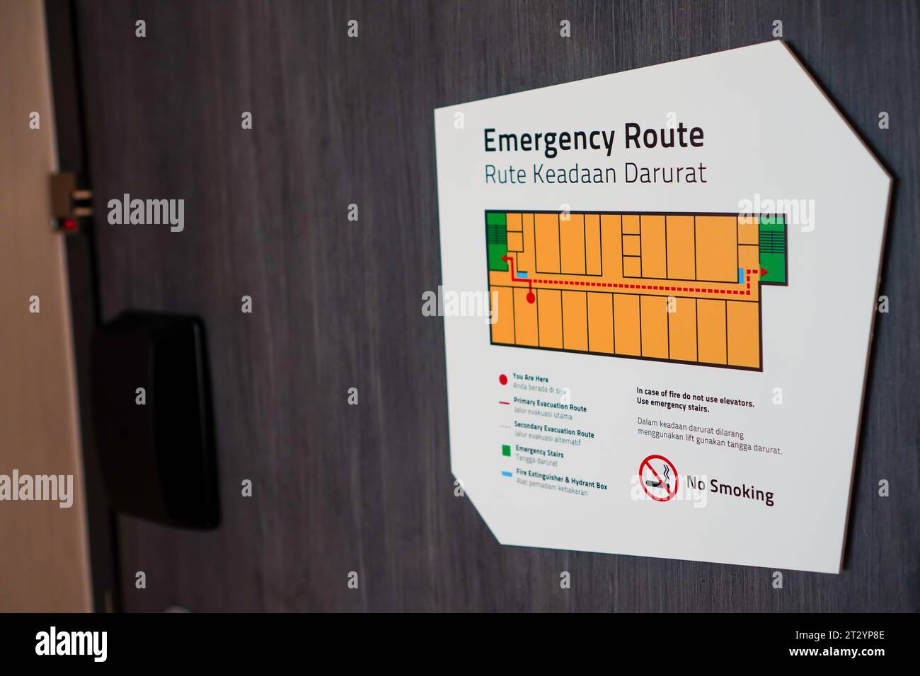 Emergency route signs displayed on the hotel room door Stock Photo - Alamy