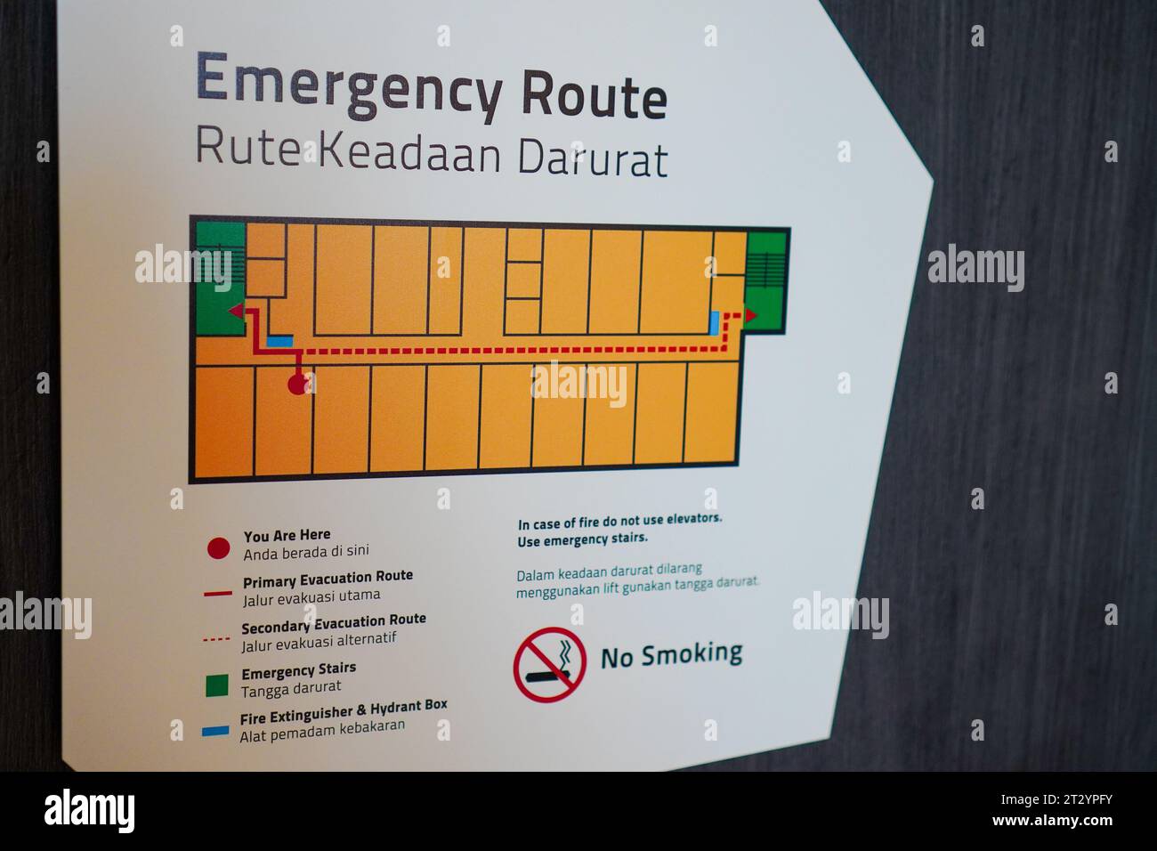 Emergency route signs displayed on the hotel room door Stock Photo - Alamy