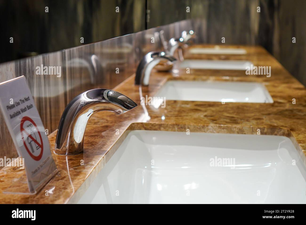 Closeup of a row of sinks with an elegant and exclusive feel with a ...