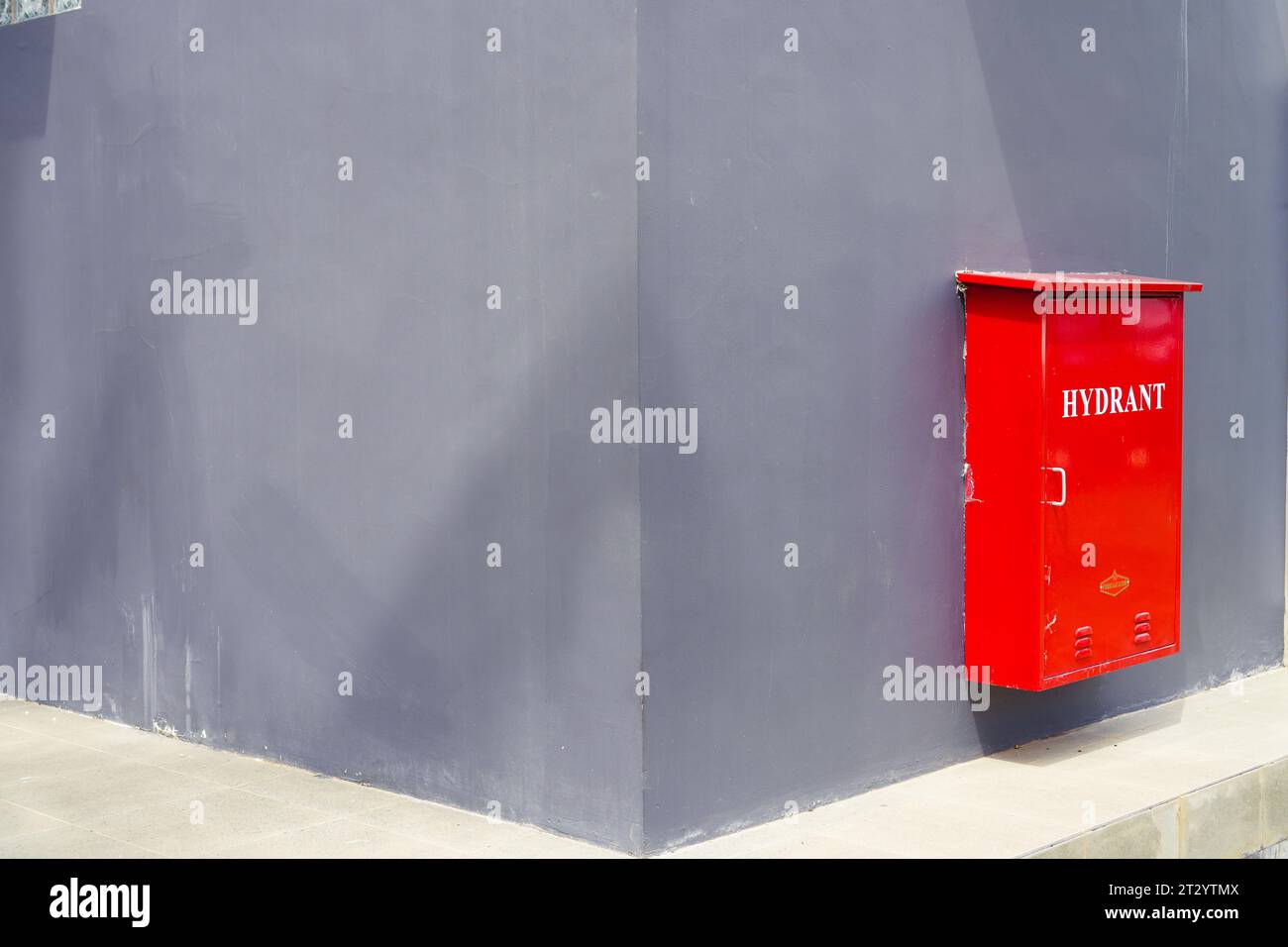 Side view of a hydrant box attached to an outdoor wall. With copy space ...