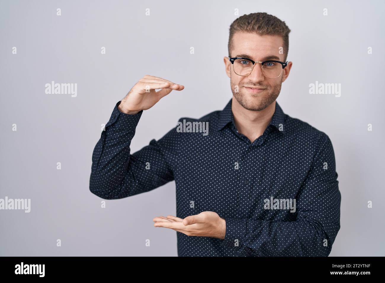 Young caucasian man standing over isolated background gesturing with ...