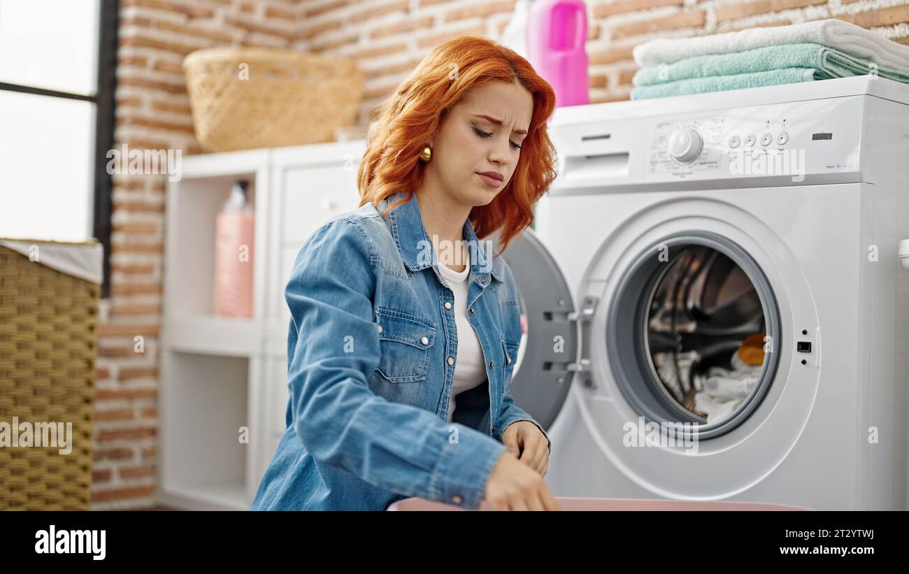 Young redhead woman washing clothes hi-res stock photography and images ...