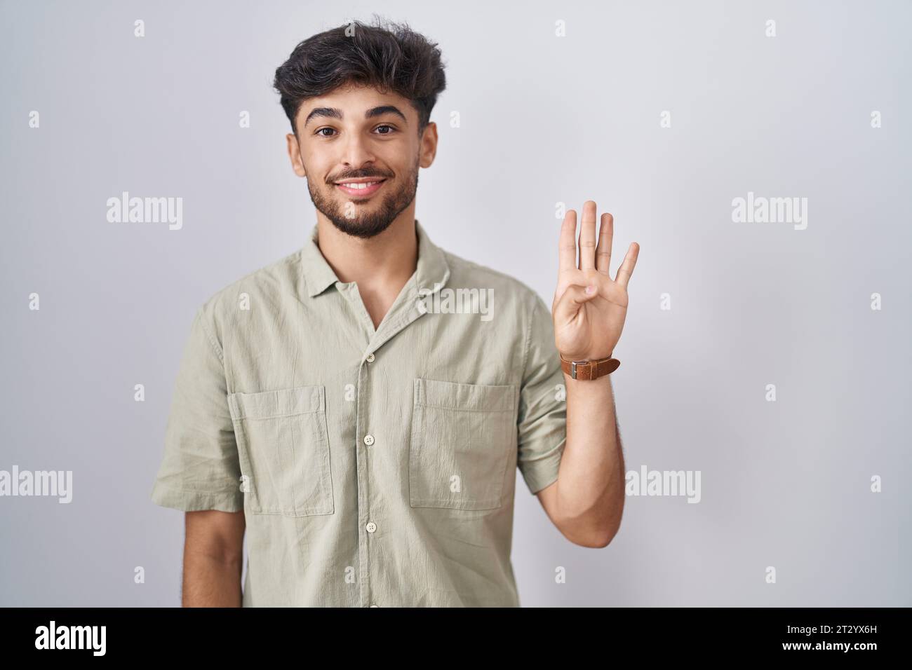 Arab man with beard standing over white background showing and pointing ...
