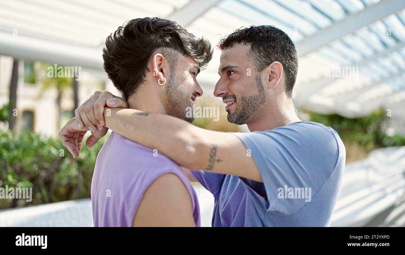 Two men couple smiling confident hugging each other at park Stock Photo ...
