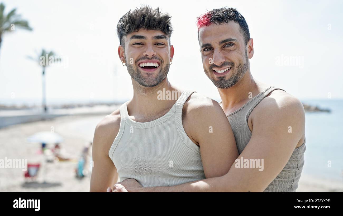 Two men couple smiling confident hugging each other at seaside Stock ...