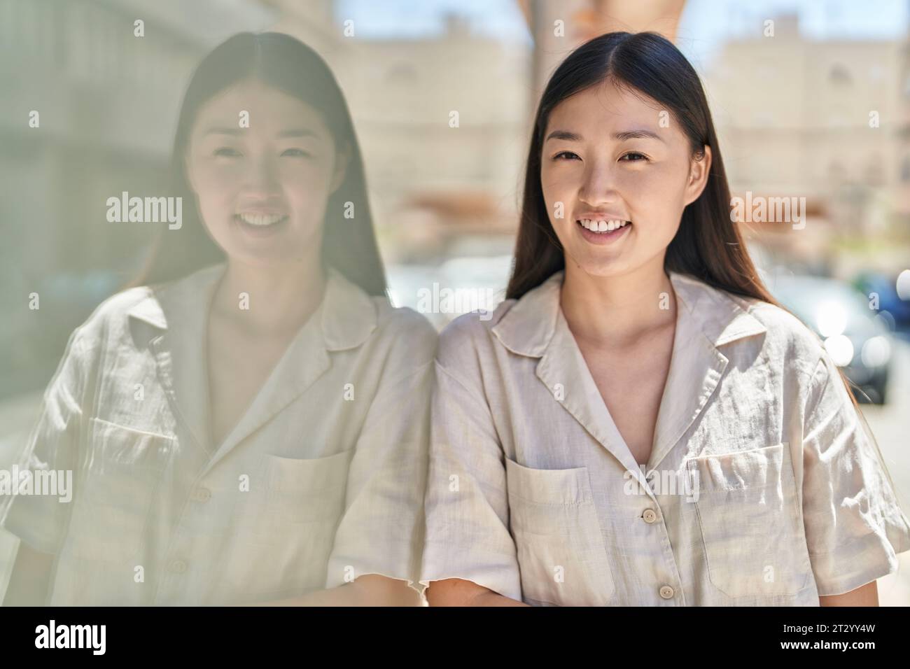 Chinese woman smiling confident standing at street Stock Photo - Alamy