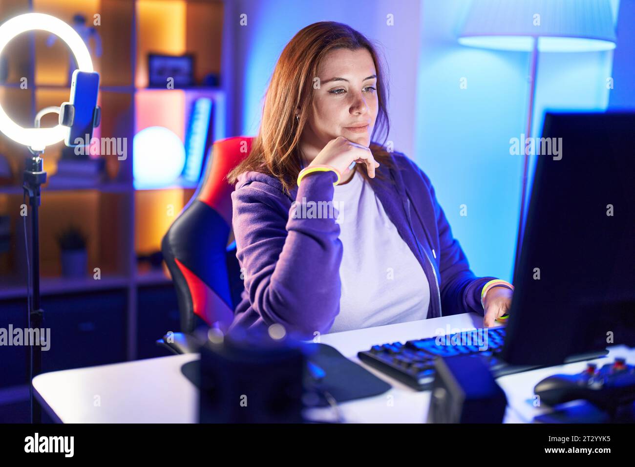 Young beautiful plus size woman streamer playing video game using ...