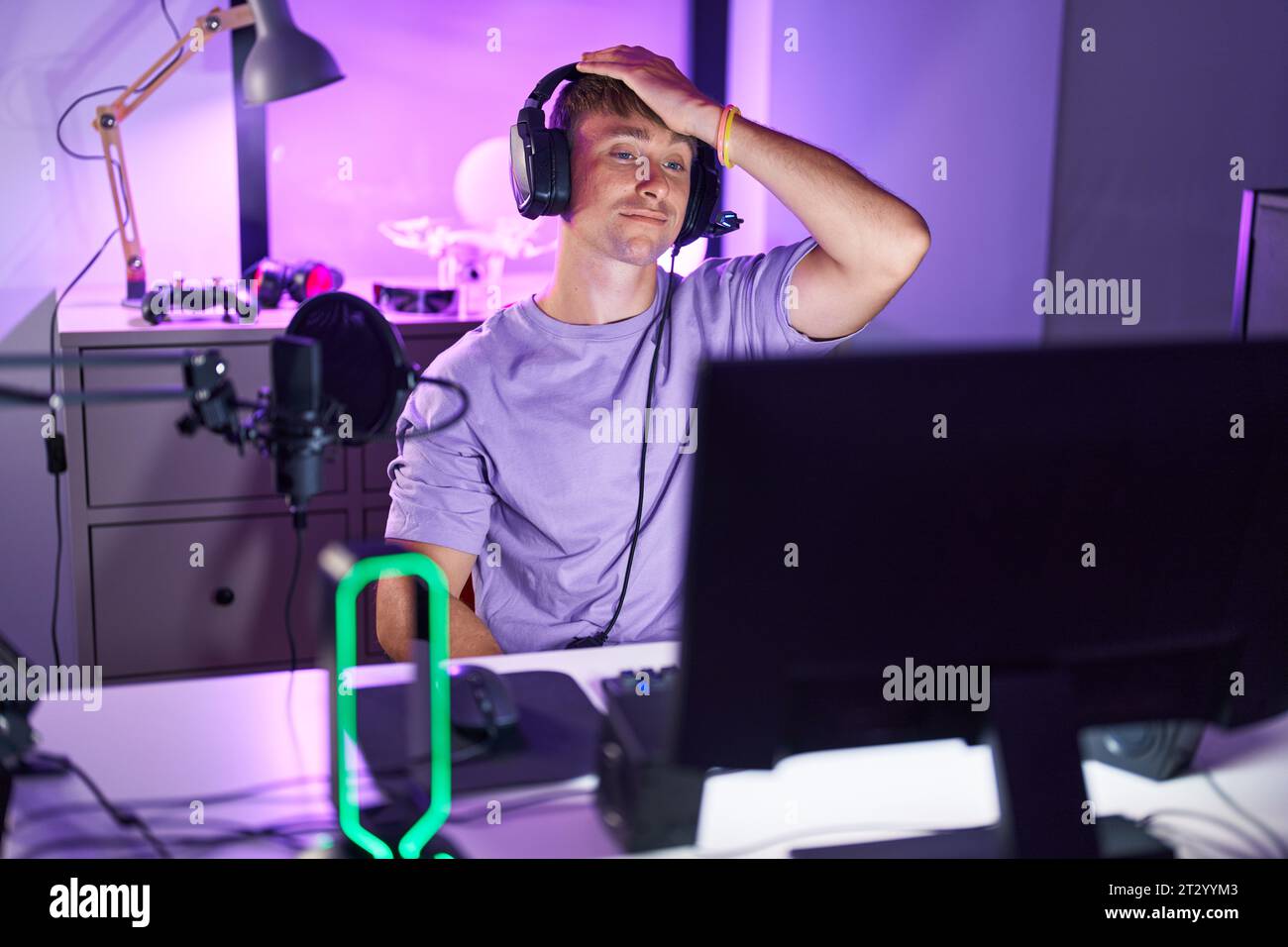 Young caucasian man streamer stressed using computer at gaming room ...