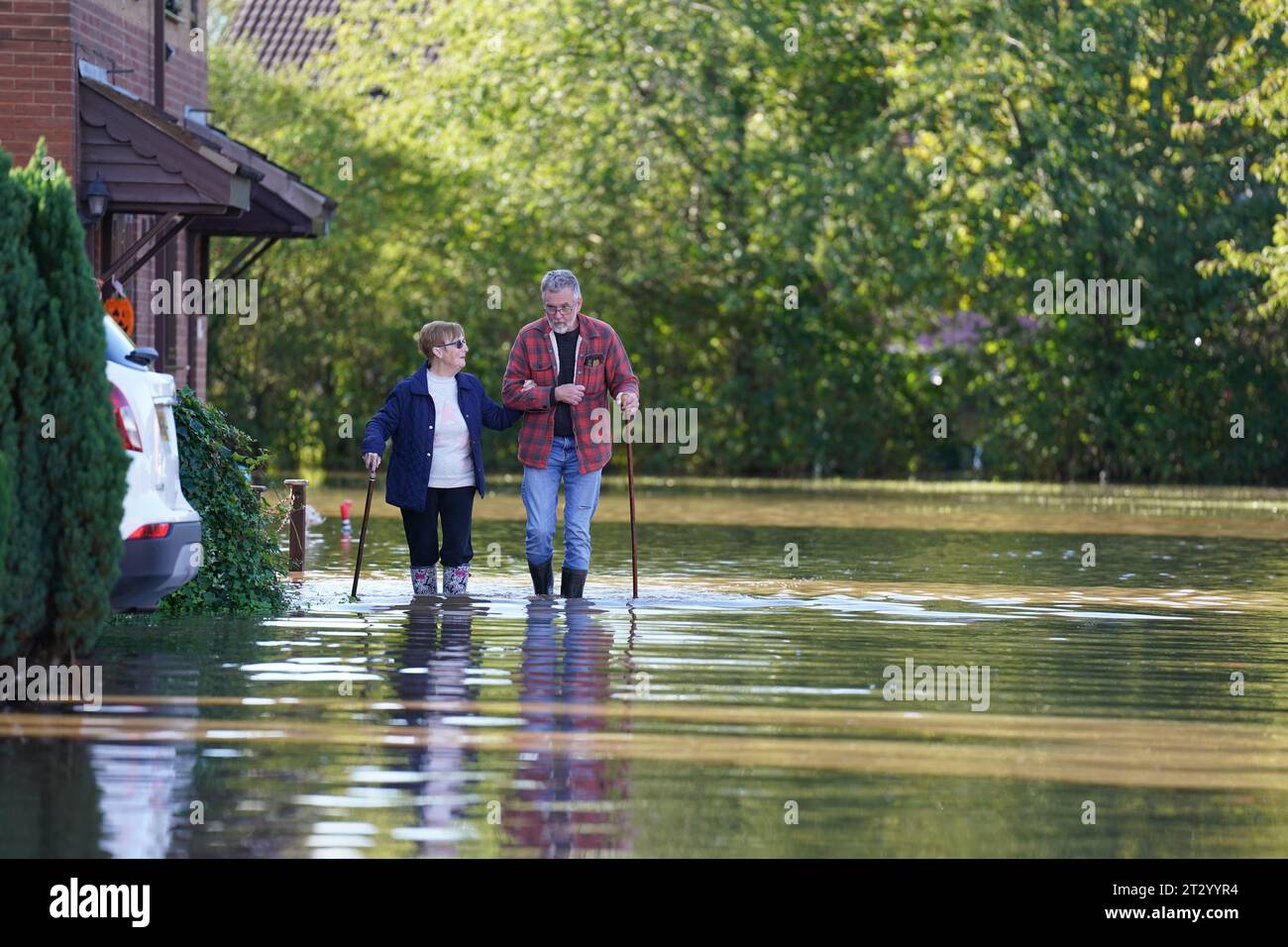 Residents walk through flood water in Retford in Nottinghamshire, after ...