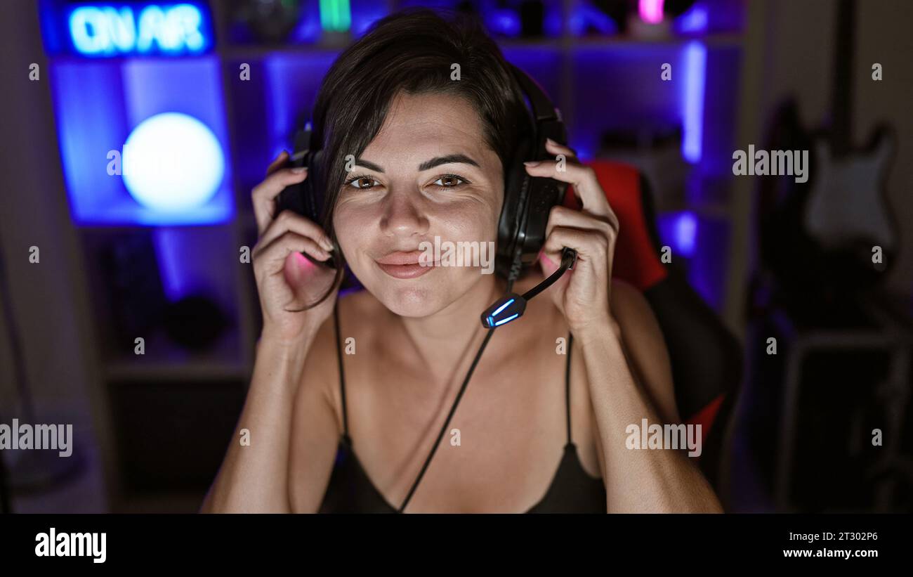 Vibrant young hispanic woman streamer confidently smiling, sporting ...