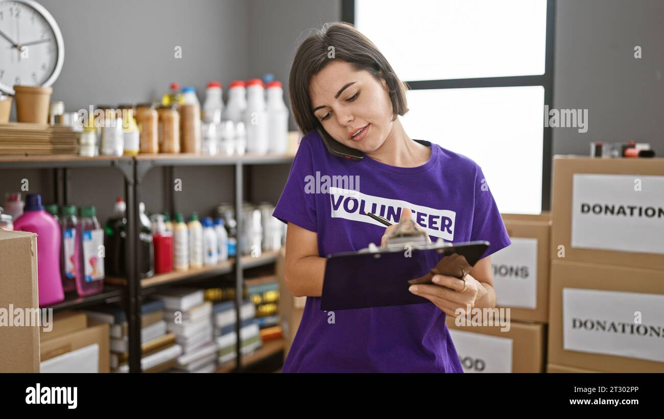 Young beautiful hispanic woman volunteer talking on smartphone taking ...