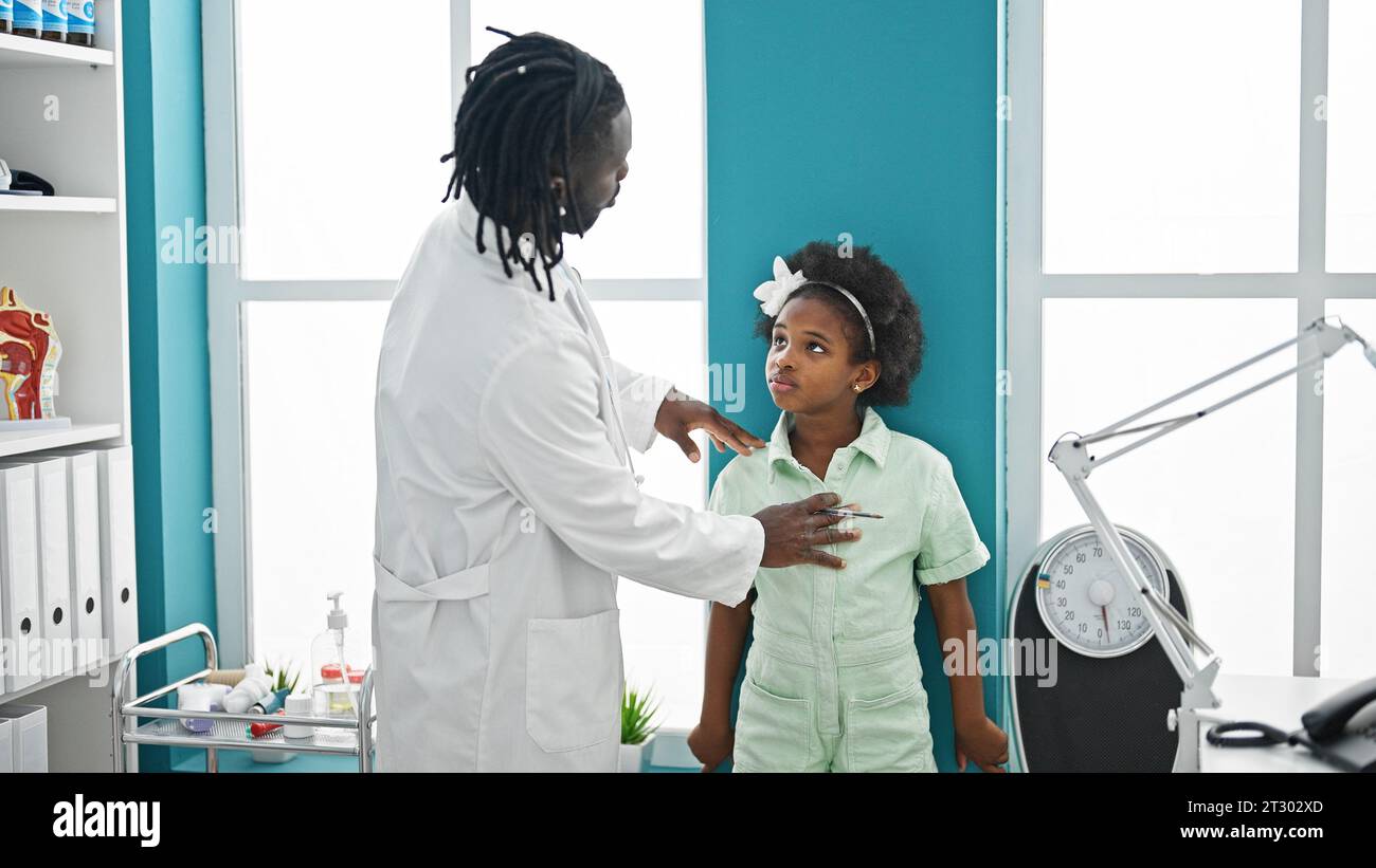 Doctor and patient having medical consultation measuring height at the ...