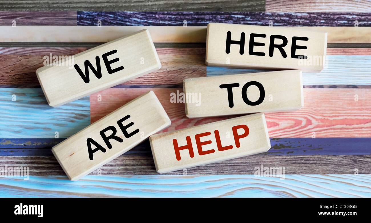 Conceptual words we are here to help on wooden blocks. Beautiful ...