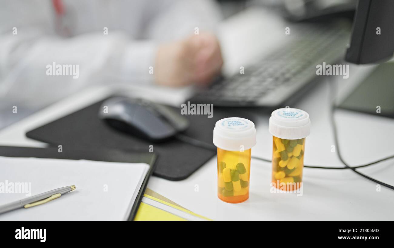 Young beautiful hispanic woman doctor prescribing pills at the clinic ...