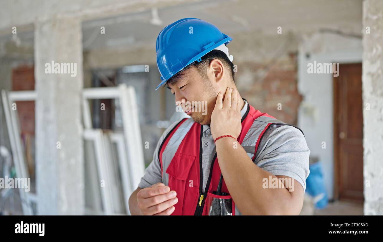 builder tired standing with serious expression at construction site ...