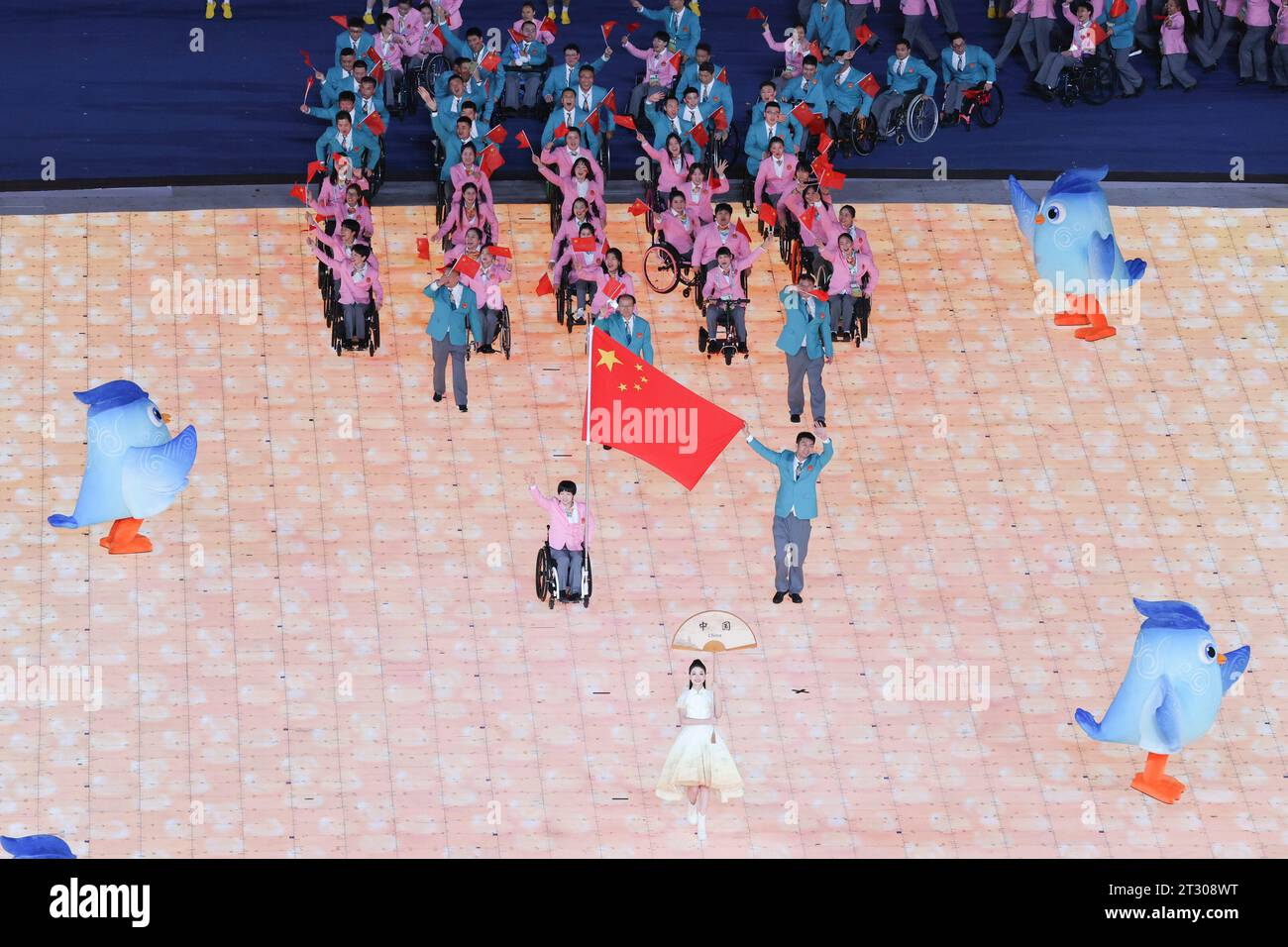 Hangzhou, R) parade into the Hangzhou Olympic Sports Center Stadium ...