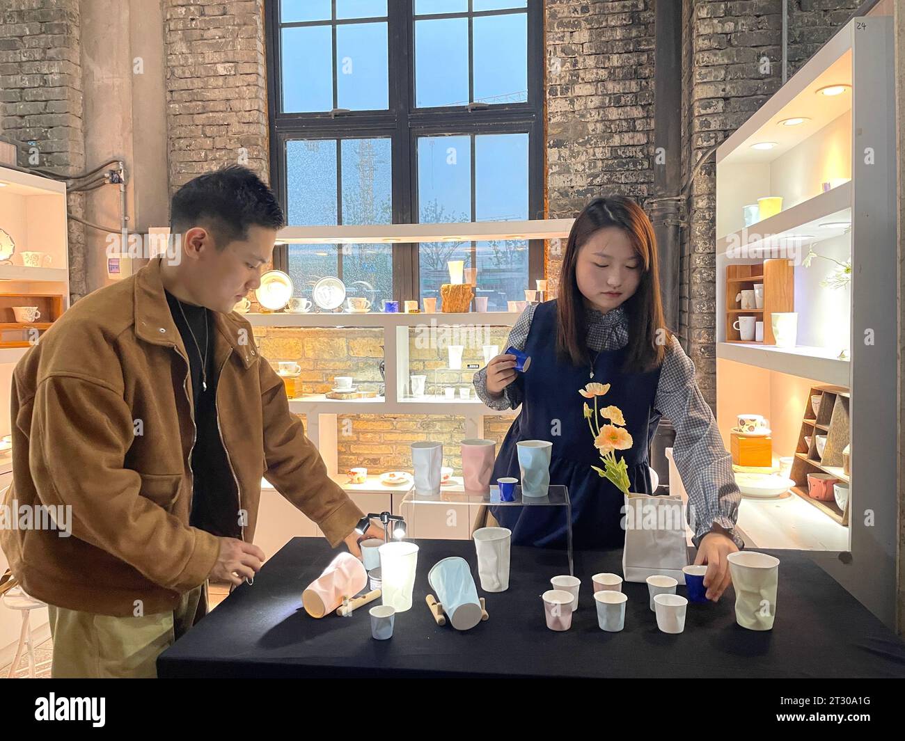 Jingdezhen, China's Jiangxi Province. 12th Oct, 2023. Hu Xiaoyun and her husband arrange her ...