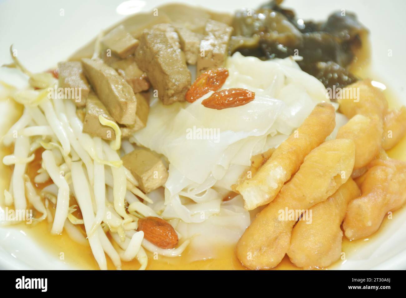 steamed large rice noodles topping slice tofu and mushroom with bean ...