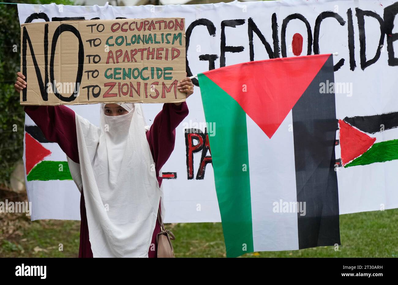 A Kenyan woman holds a Palestinian flag and a placard during a pro ...