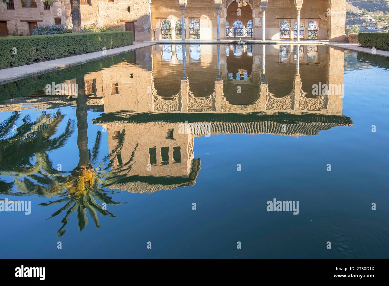 reflections of the fortress and palace of the alhambra in granada ...