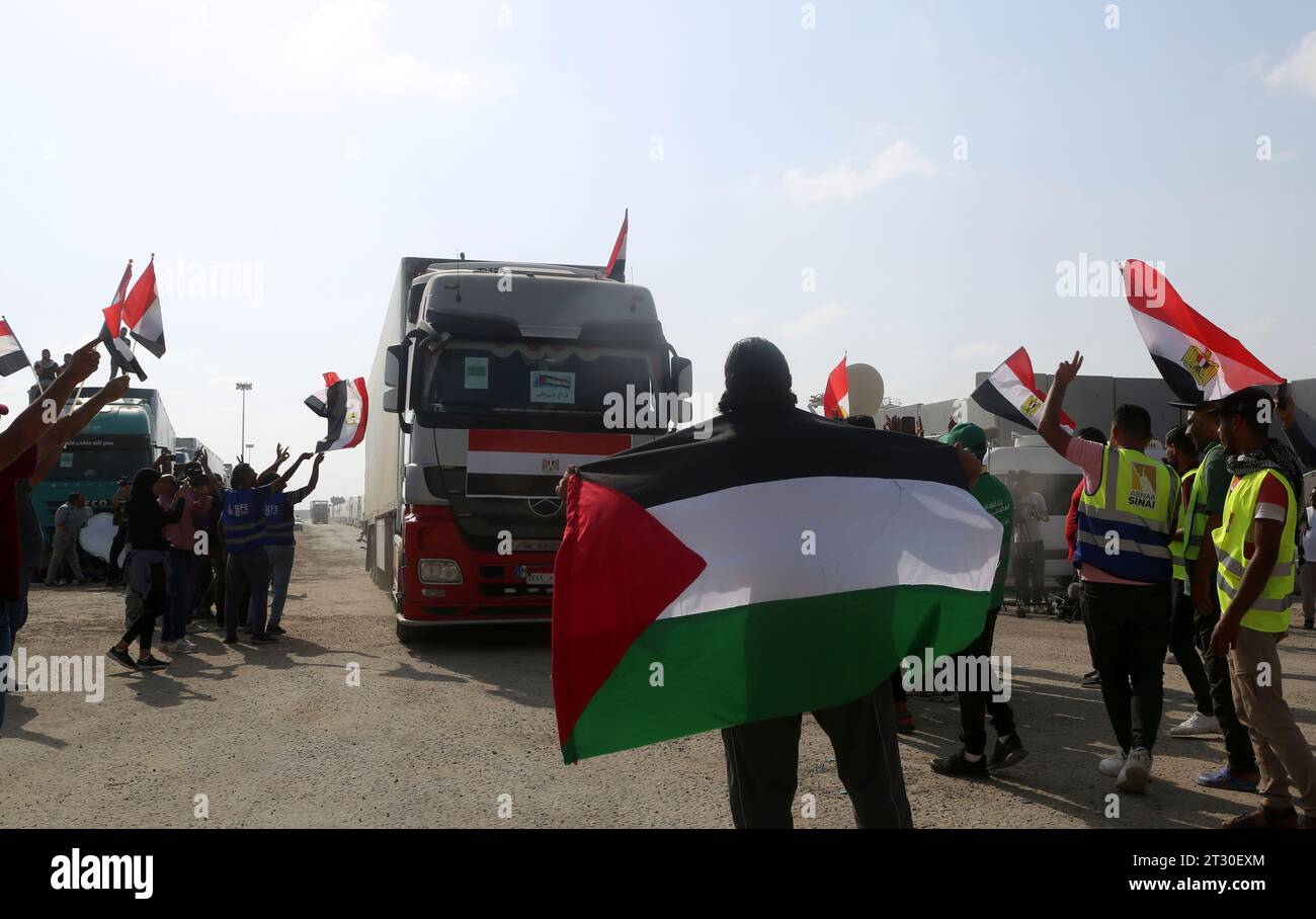Volunteers wave Palestinian and Egyptian flags to a truck carrying ...