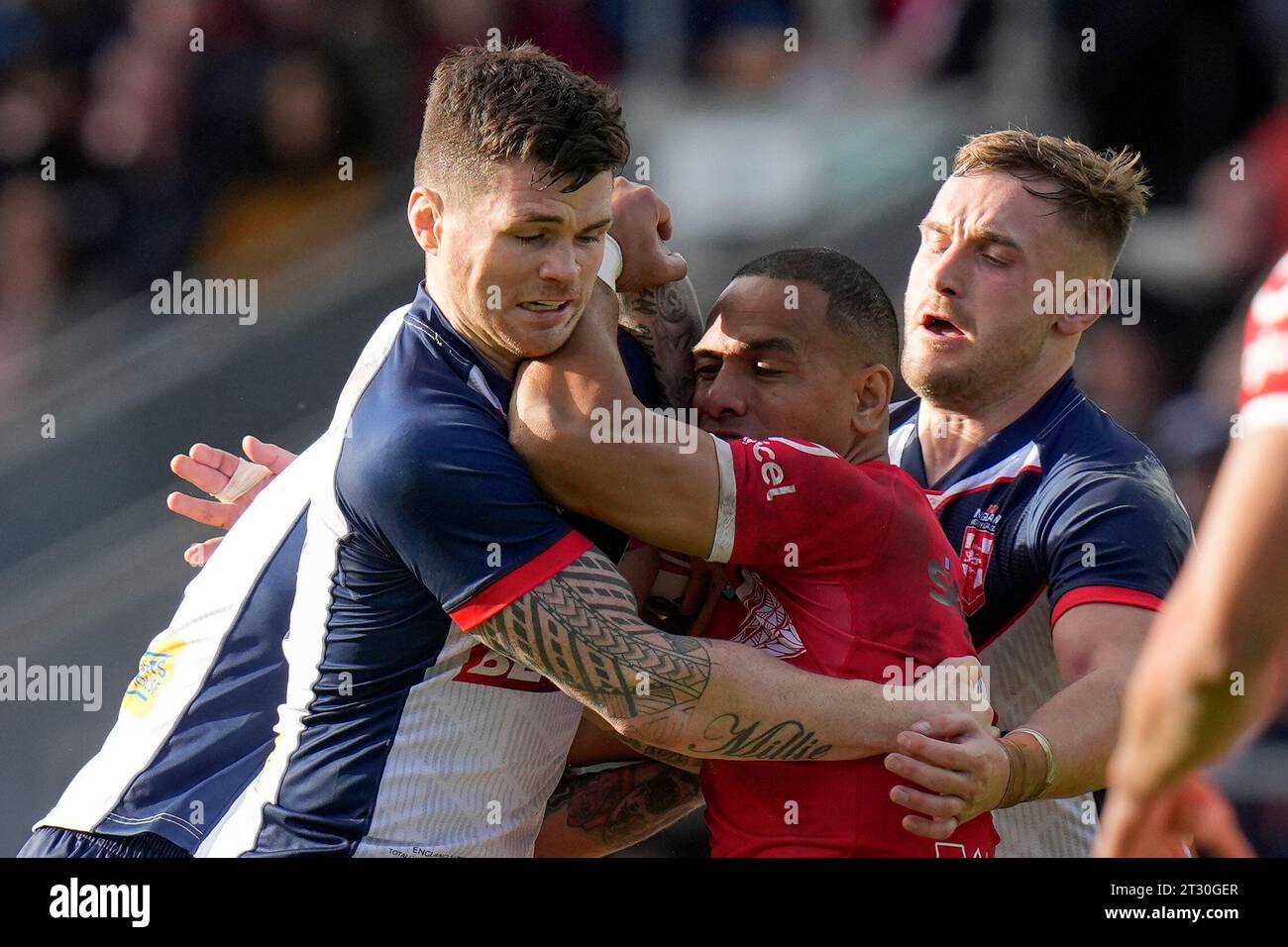 John Bateman #11 of England tackles Will Hopoate #1 of Tonga during the ...