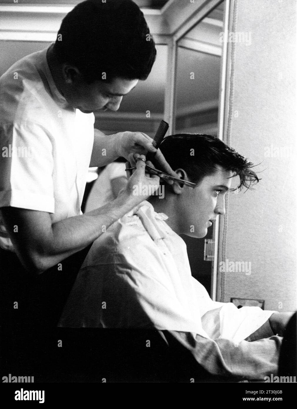 ELVIS PRESLEY has his hair cut by hairdresser / barber RAMIRO JALOMA at ...