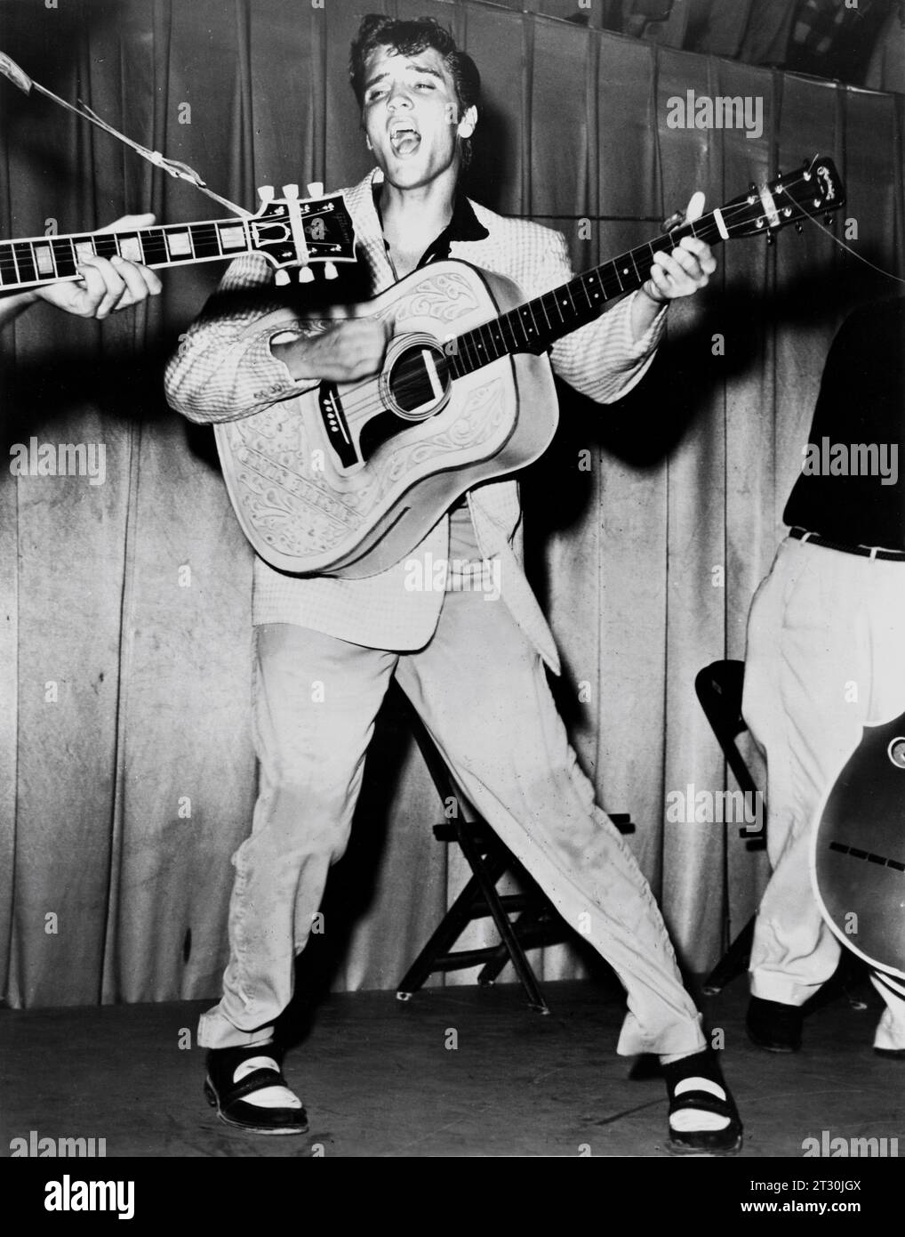 ELVIS PRESLEY on stage in 1956 playing his guitar and singing Stock ...
