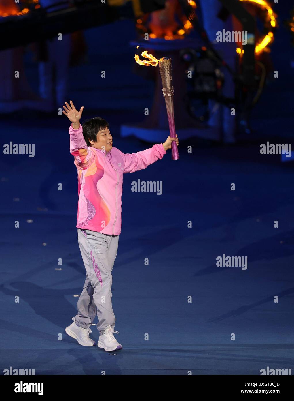 Hangzhou. 22nd Oct, 2023. Torch bearer Zheng Xiongying runs with the ...