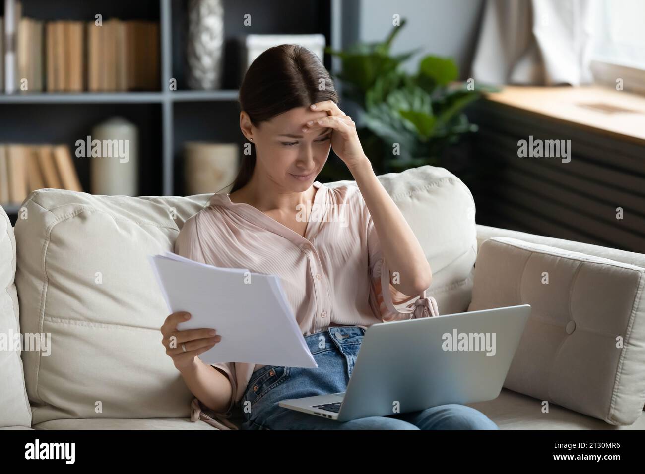 Stressed woman checks online e-banking statement feels desperate Stock ...