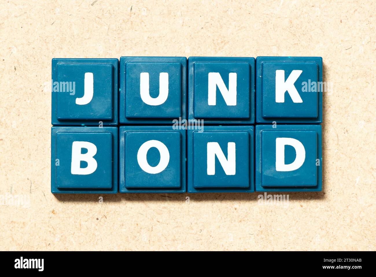 Tile alphabet letter in word junk bond on wood background Stock Photo ...