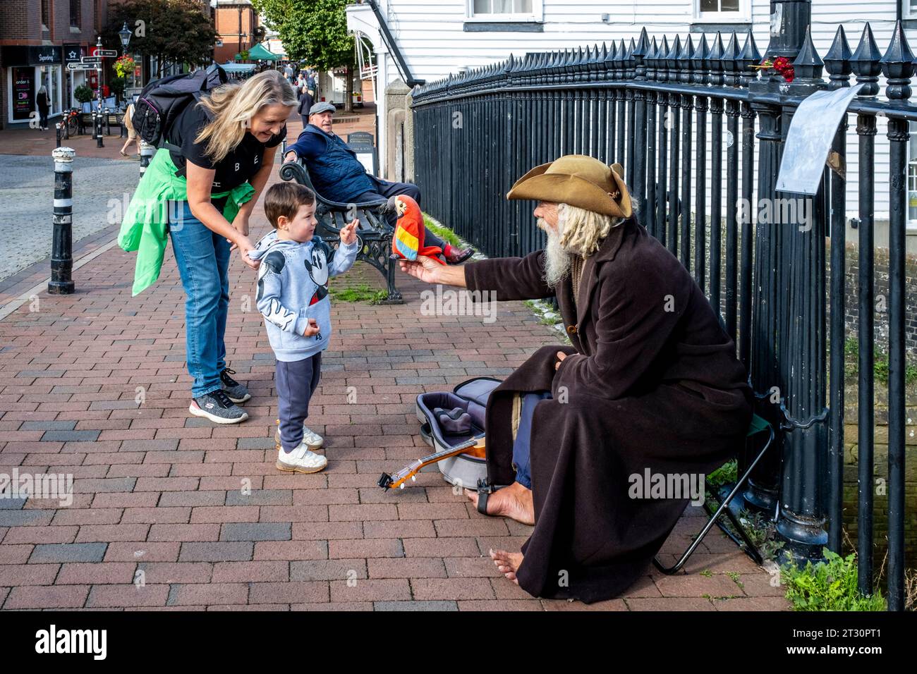 A Child Watches A Pirate Street Entertainer With His Toy Parrot, High ...