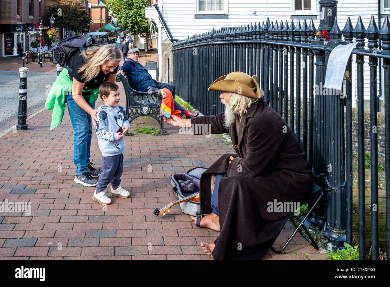 A Child Watches A Pirate Street Entertainer With His Toy Parrot, High ...