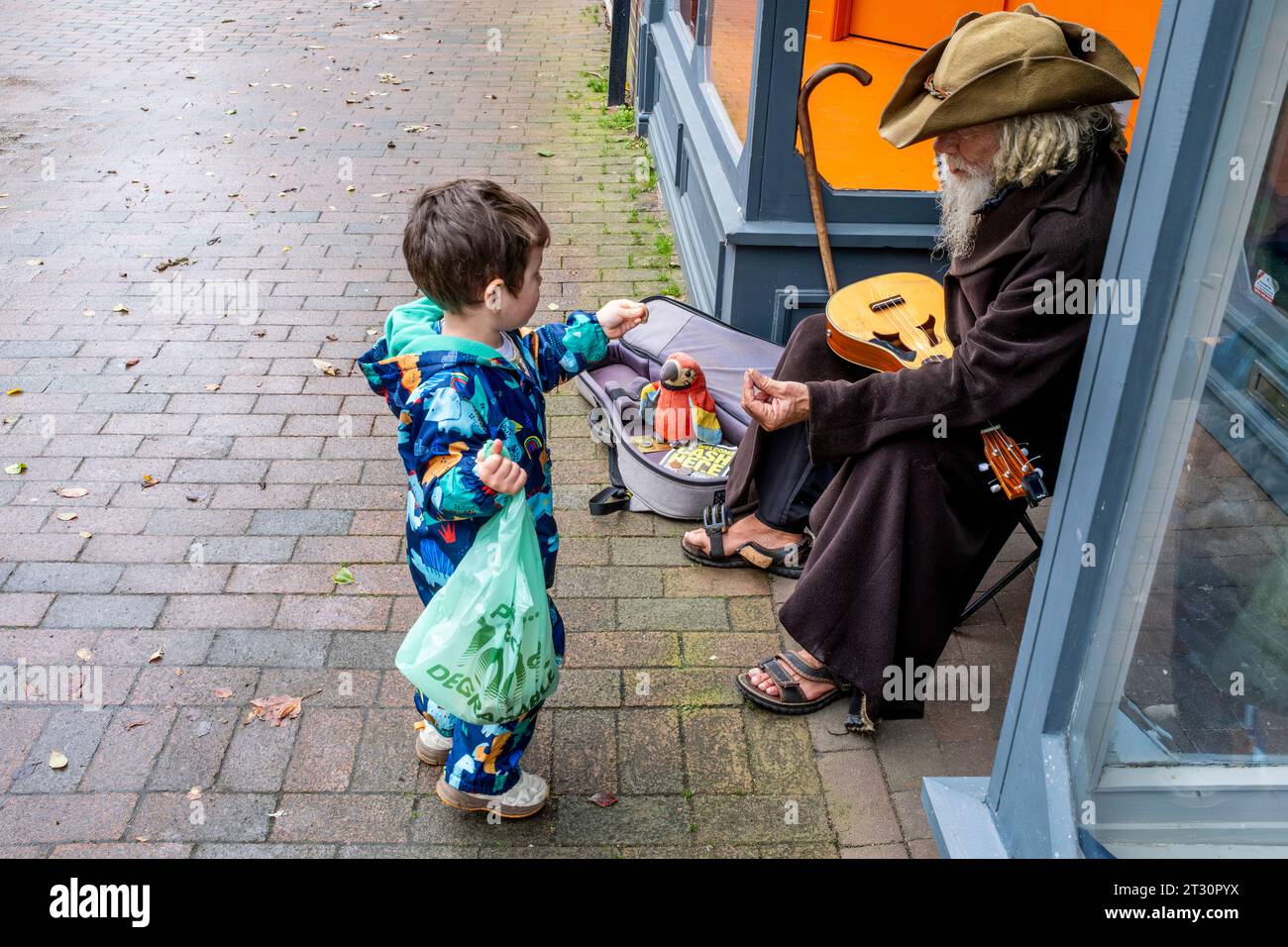 A Child Watches A Pirate Street Entertainer With His Toy Parrot, High ...